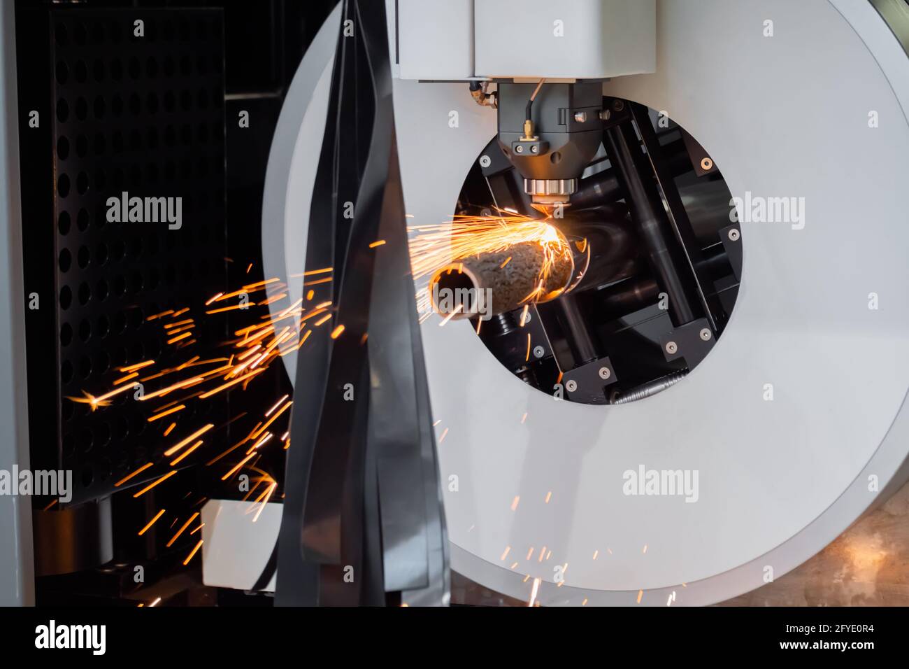 Laser cutting machine working with cylindrical metal workpiece with ...