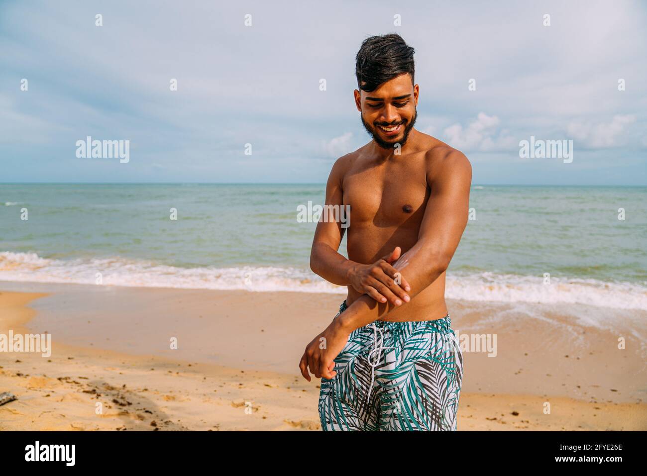 happy young latin american man on the beach. Brazilian model of perfect ...