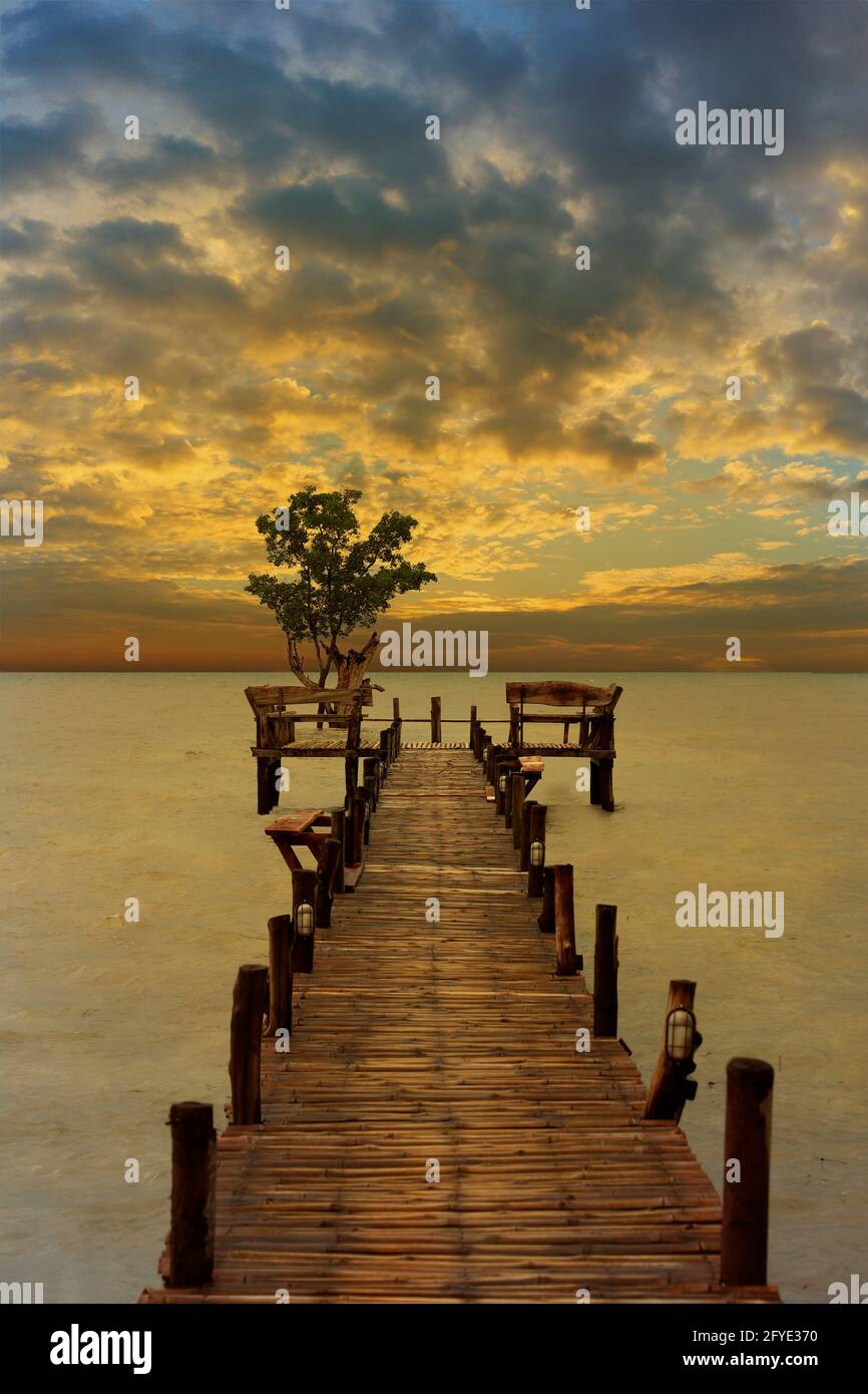 sunset on the bridge jetty in the middle of the sea Stock Photo - Alamy