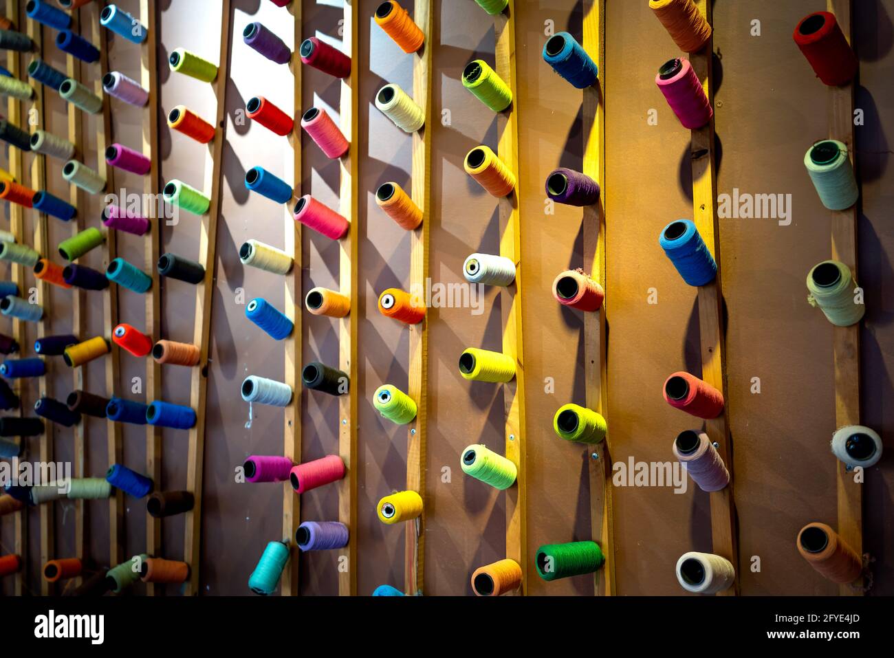 Decorate colorful spools of thread on the wall at a cafe Stock Photo ...