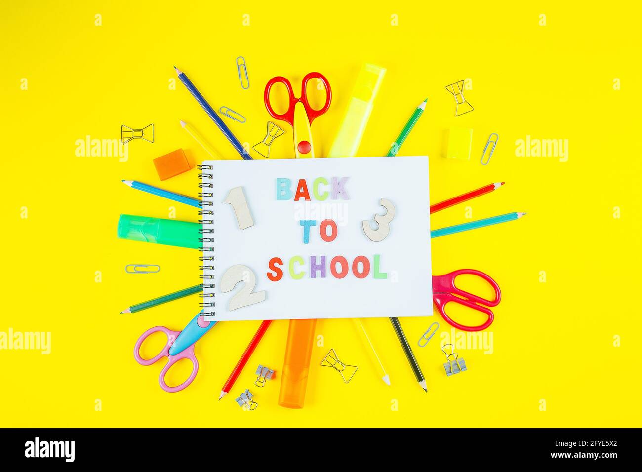 Back to school concept. Open notebook and various colored stationery ...