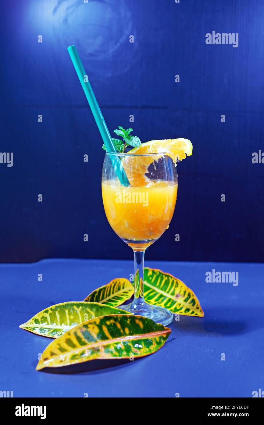 Fresh orange juice in transparent glass on deep blue background Stock ...