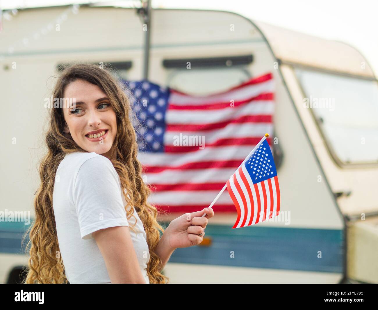 Blonde Caucasian female posing with the US flag Stock Photo - Alamy