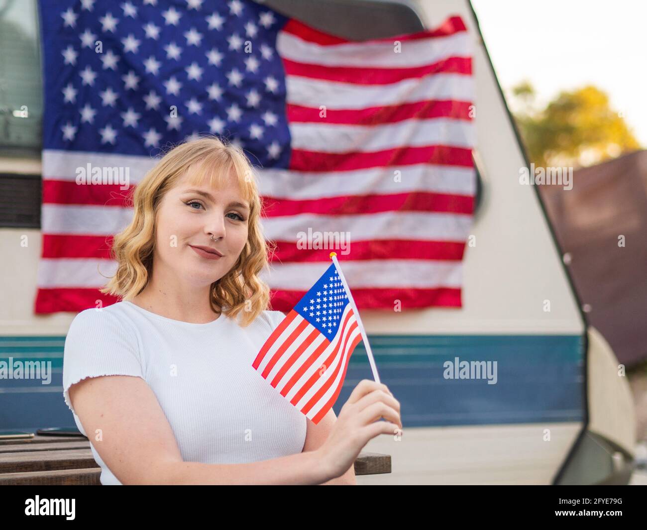 Blonde Caucasian female posing with the US flag Stock Photo - Alamy