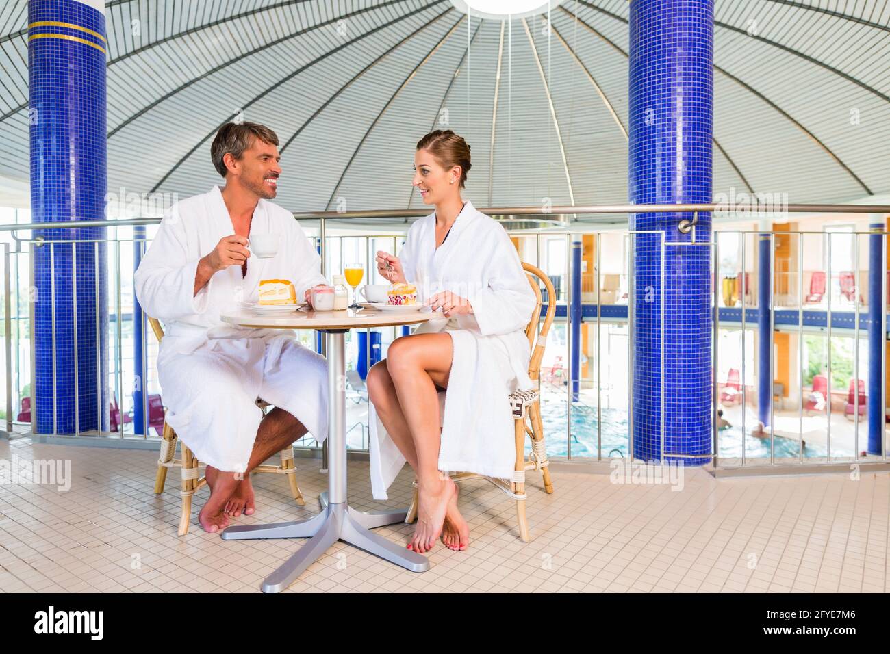 Woman and man eating snack with coffee and cake in thermal spa Stock ...