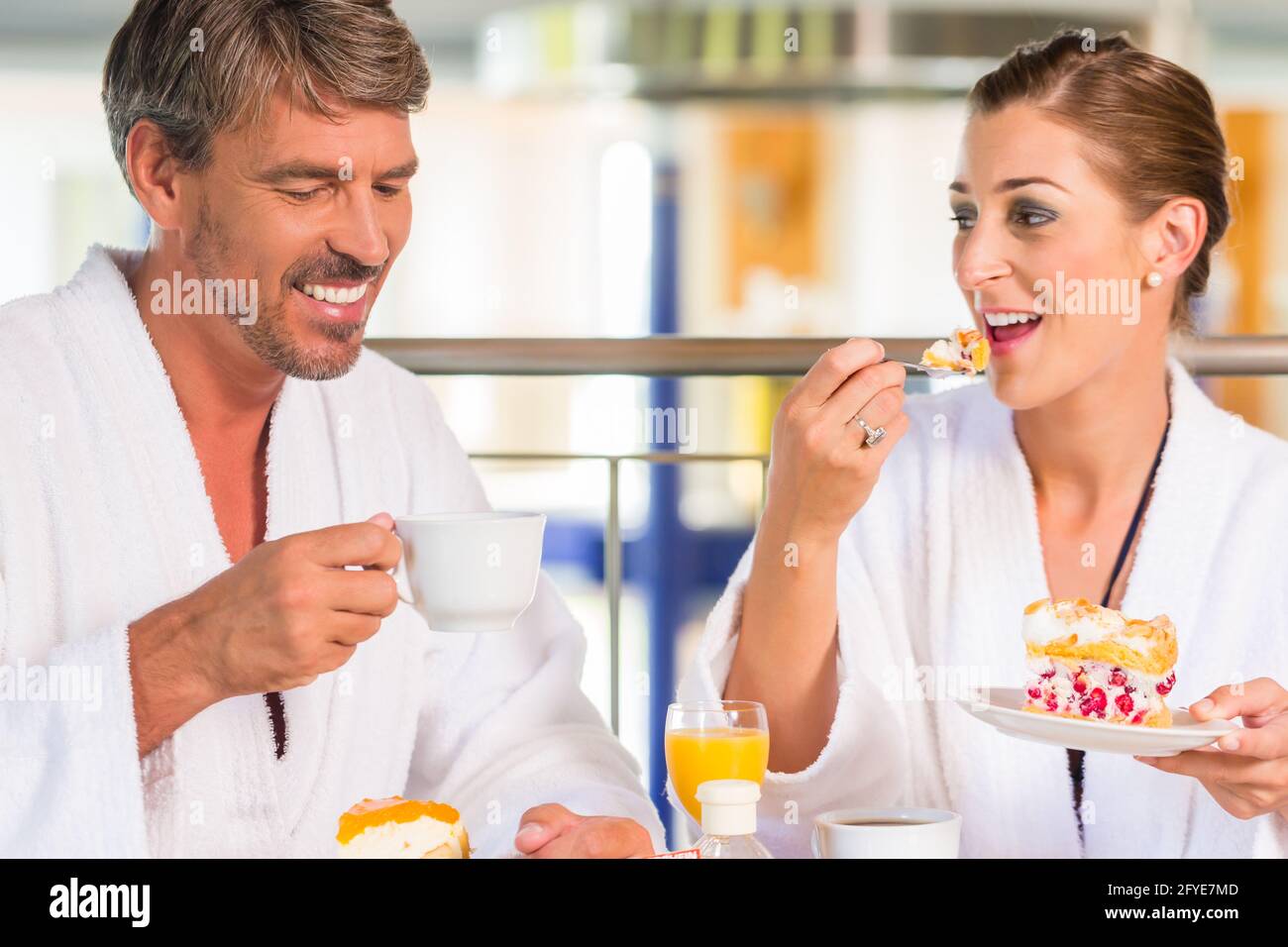 Woman and man eating snack with coffee and cake in thermal spa Stock ...