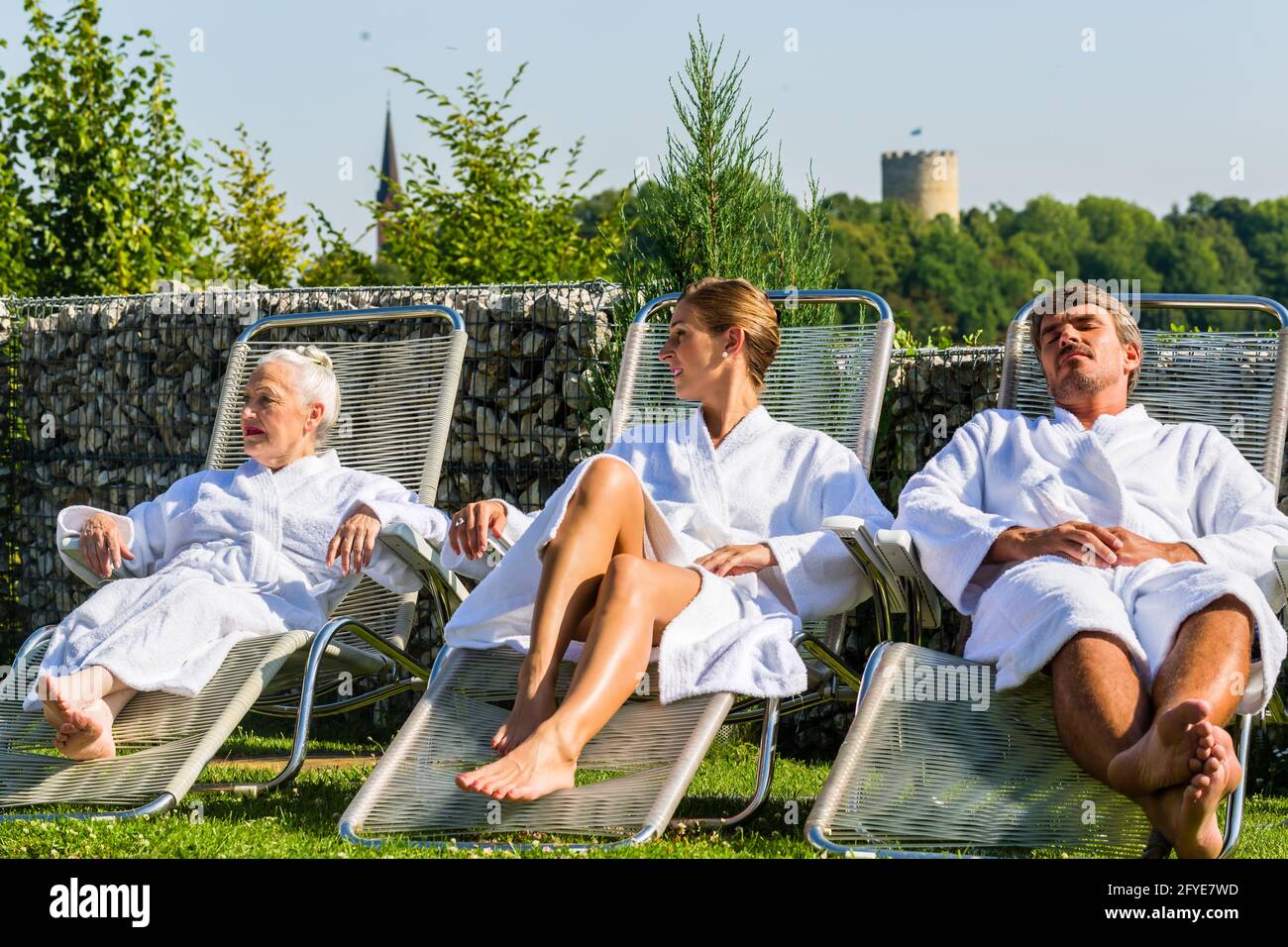 People relaxing on outdoor rest area of sauna Stock Photo - Alamy