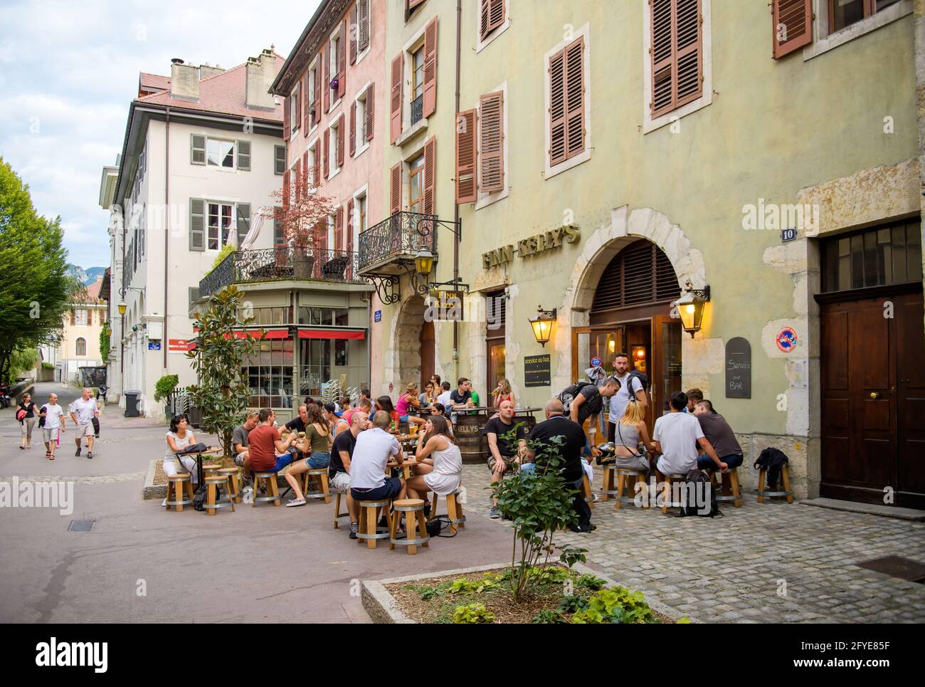 Large group of people eating drinking smoking at the outdoor terrace of ...