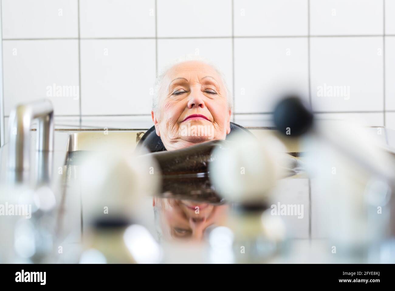 Senior woman enjoying mud bath alternative therapy Stock Photo - Alamy