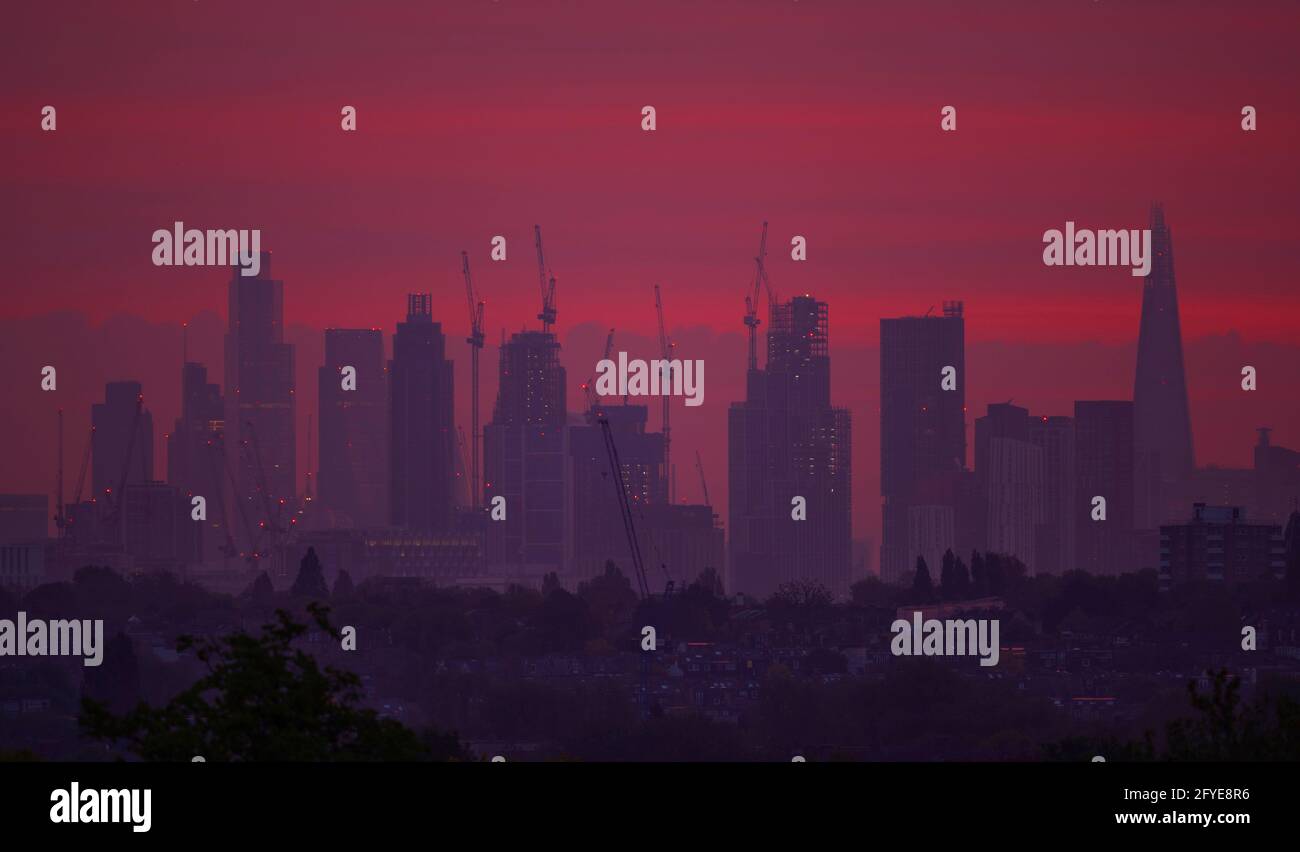 London, UK. 28 May 2021. Deep red and purple sky over City of London ...