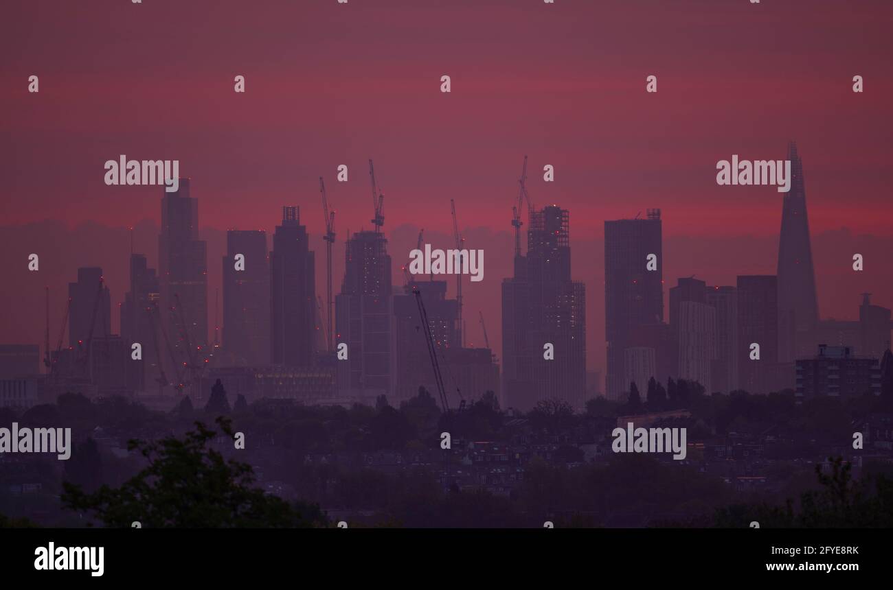 London, UK. 28 May 2021. Deep red and purple sky over City of London ...