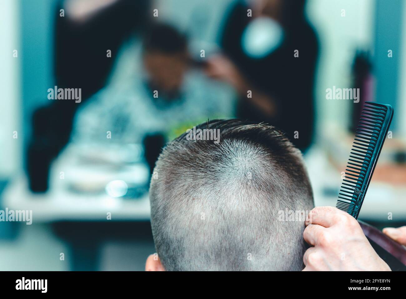 Cute kid boy have hair cut, professional barber doing haircut ...
