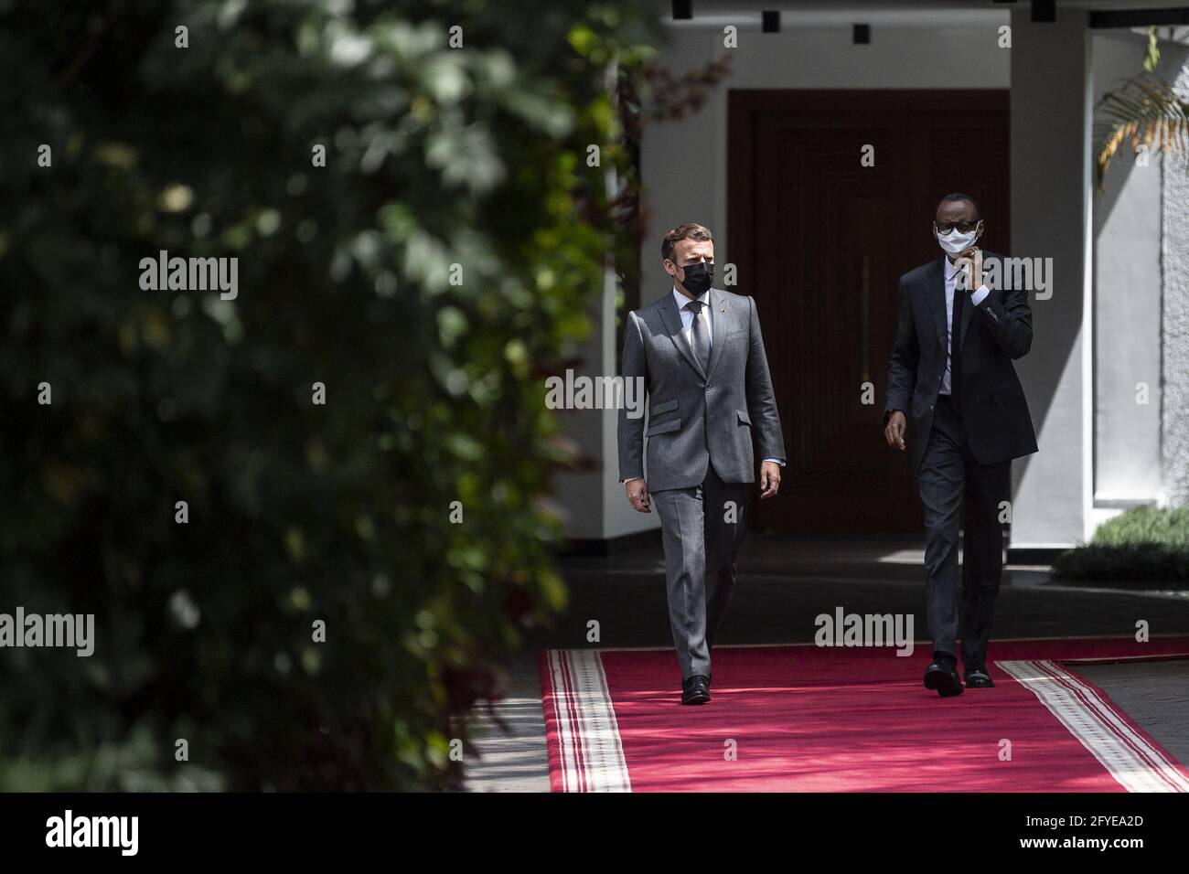 French President Emmanuel Macron (L) walks along side Rwandan President ... French President Emmanuel Macron (L) walks along side Rwandan President ...