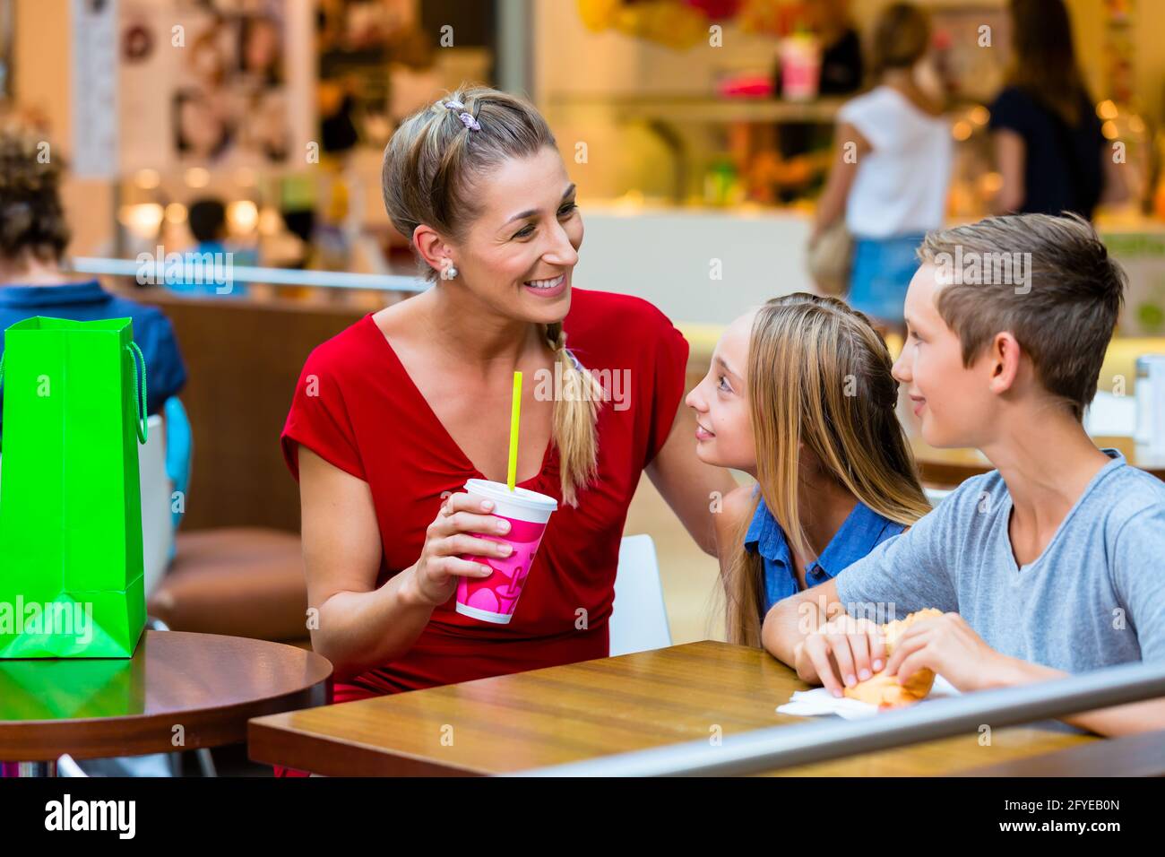 Family eating and drinking in cafe at shopping mall Stock Photo - Alamy