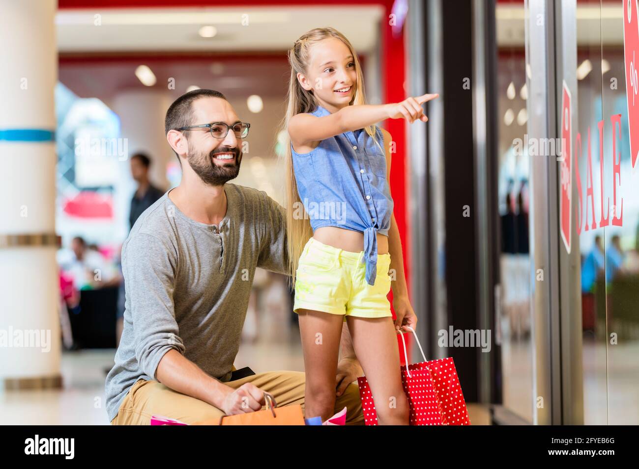 Family at shop window in mall shopping Stock Photo - Alamy