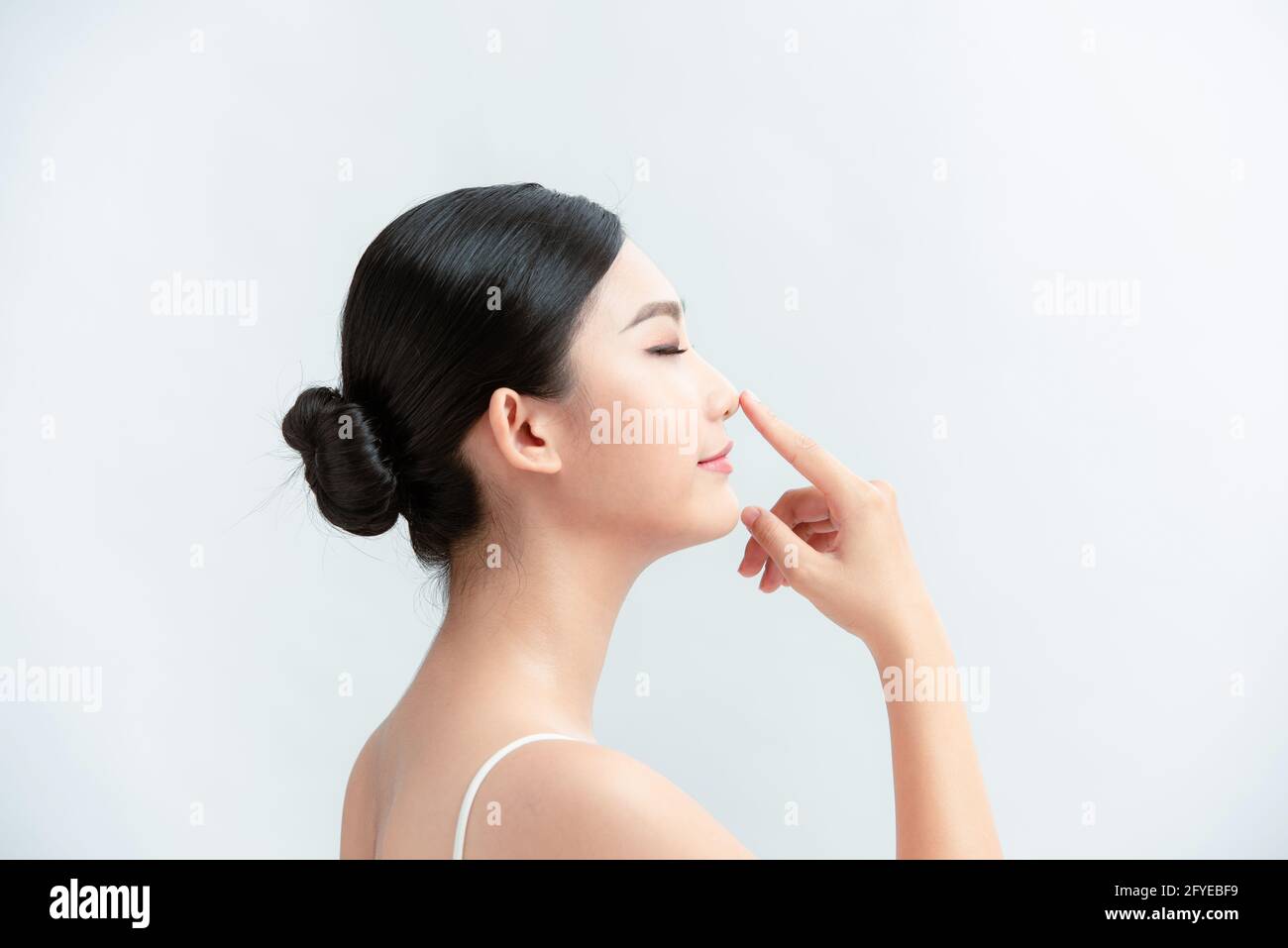 Side profile of asian lady pointing her nose Stock Photo - Alamy