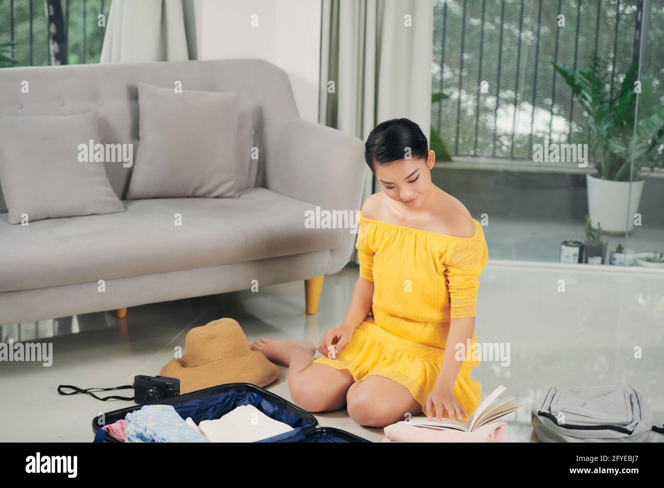 Woman packing travel bag home hi-res stock photography and images - Alamy