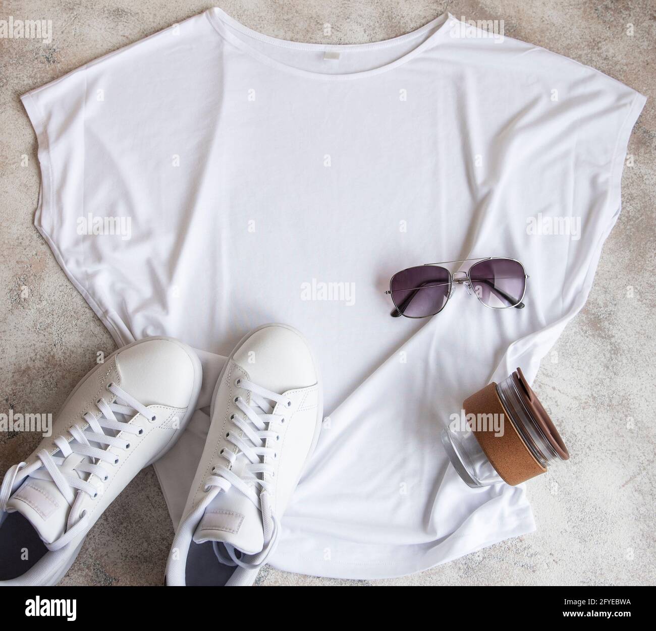 Stylish female clothes set. Woman outfit on concrete background. White ...