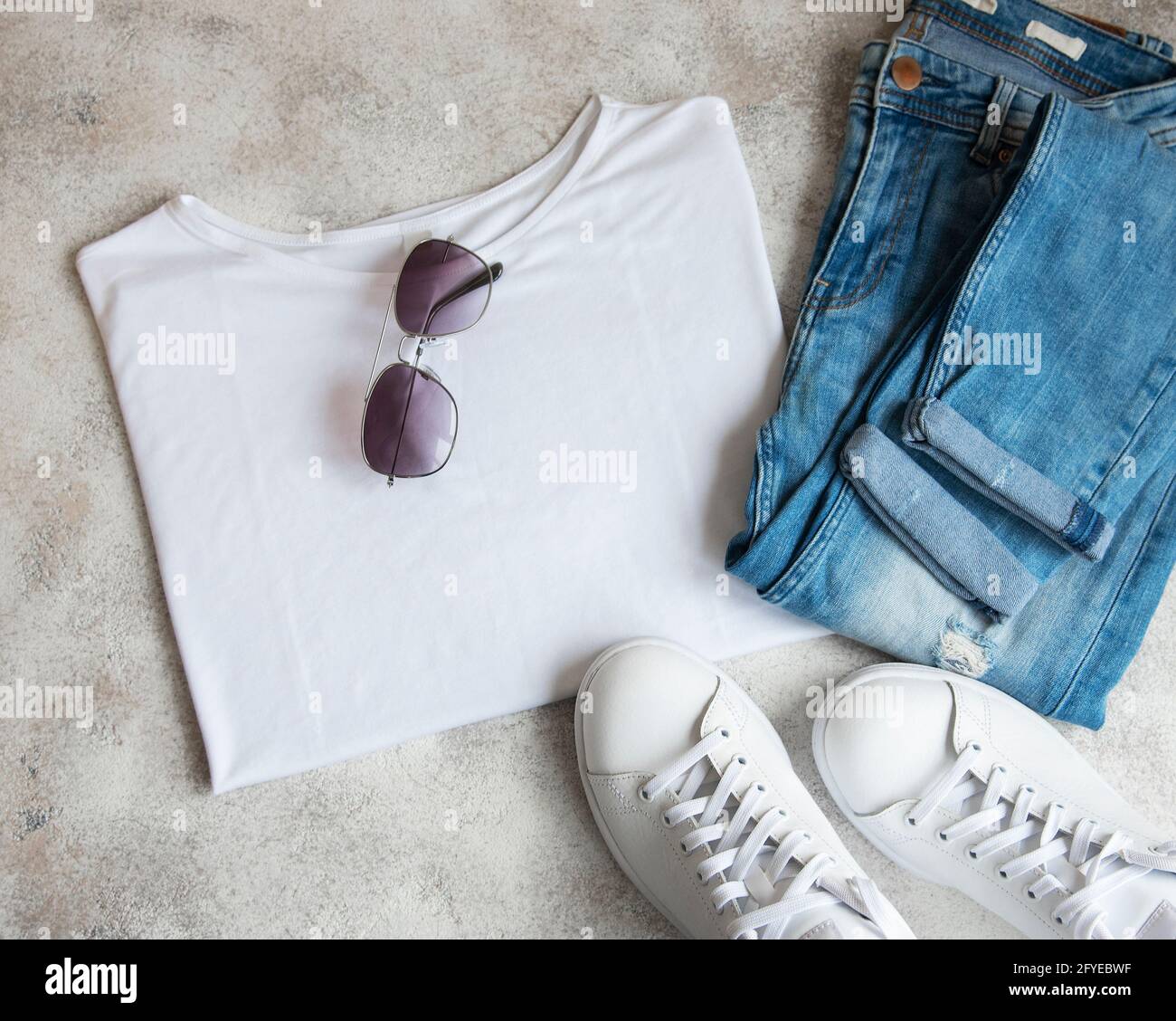 Stylish female clothes set. Woman outfit on concrete background. Blue ...