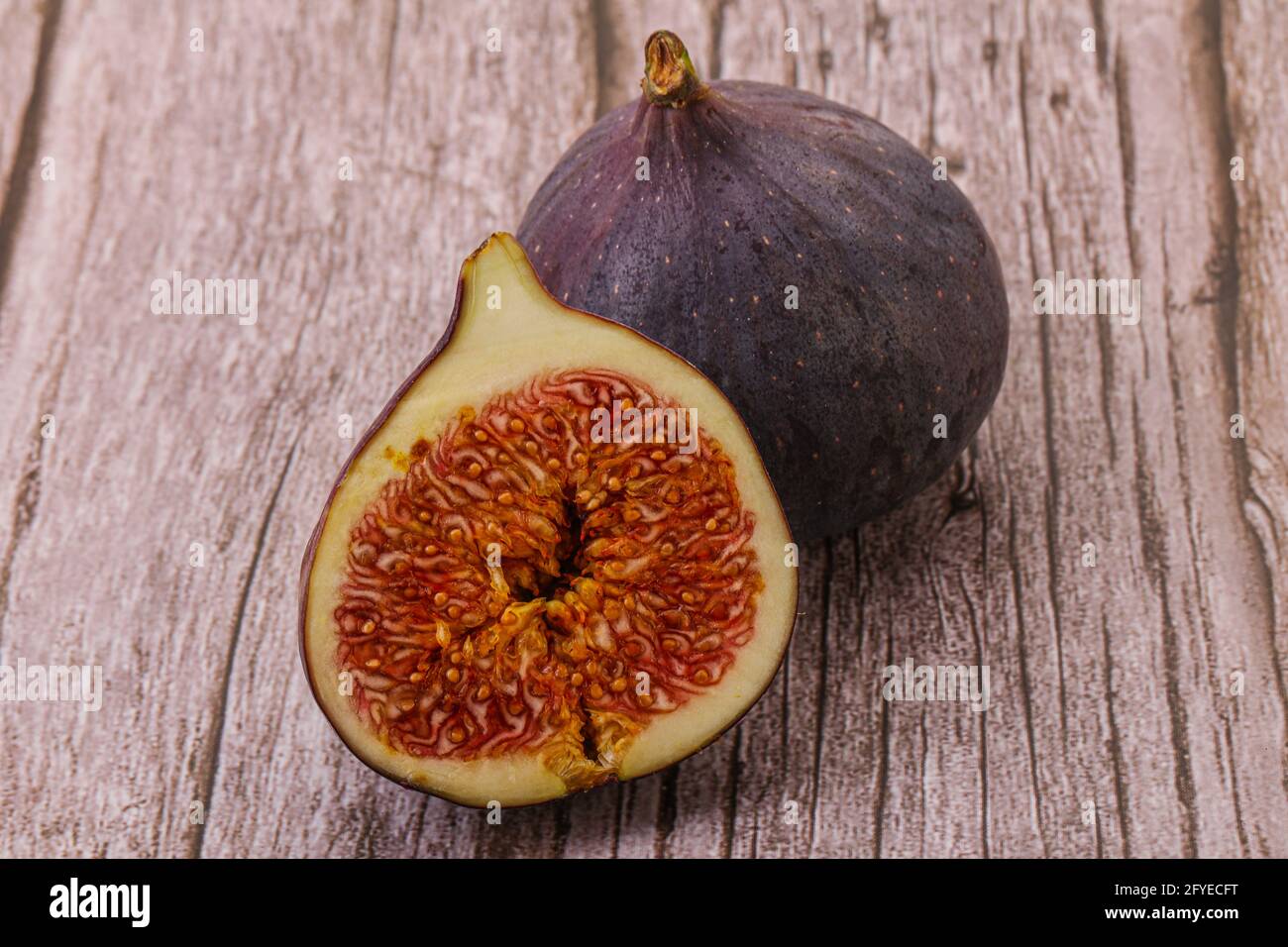 Sweet purple slice of fig fruit Stock Photo - Alamy