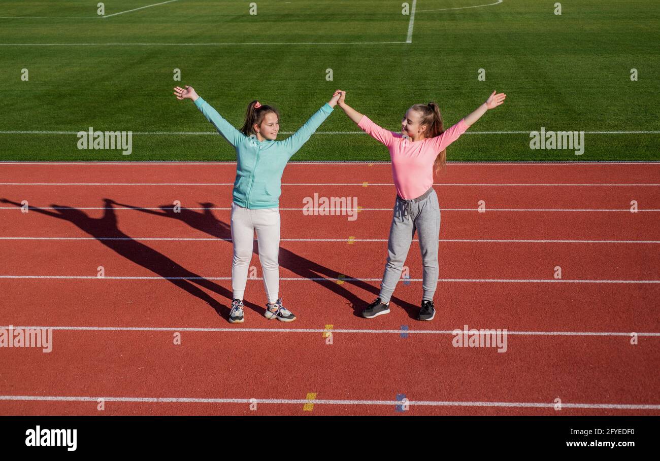 Sports really strengthen friendship. Happy friends hold hands on ...