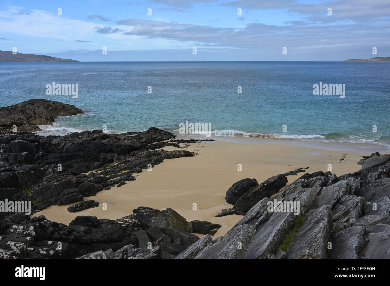 Isle of Harris pristine beach with black rocks, turquoise sea, horizon ...