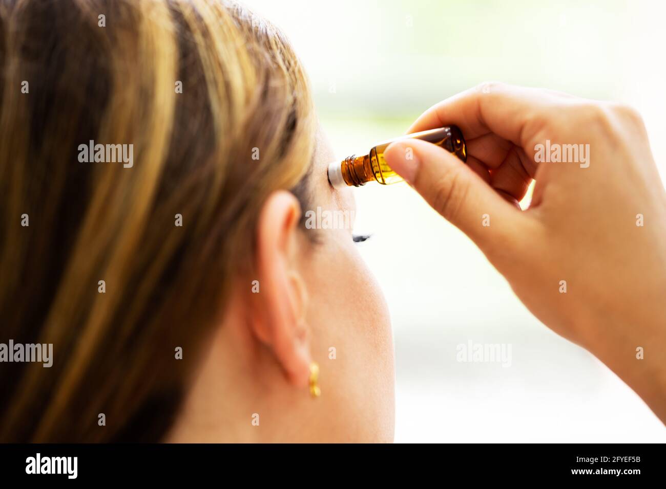Woman essential oil bottle hi-res stock photography and images - Alamy