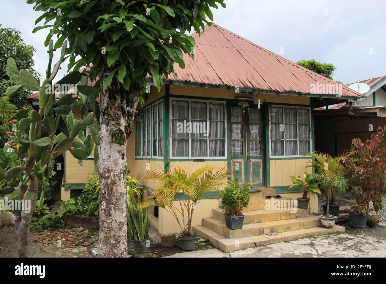 Small hut with trees and plants around it Stock Photo - Alamy