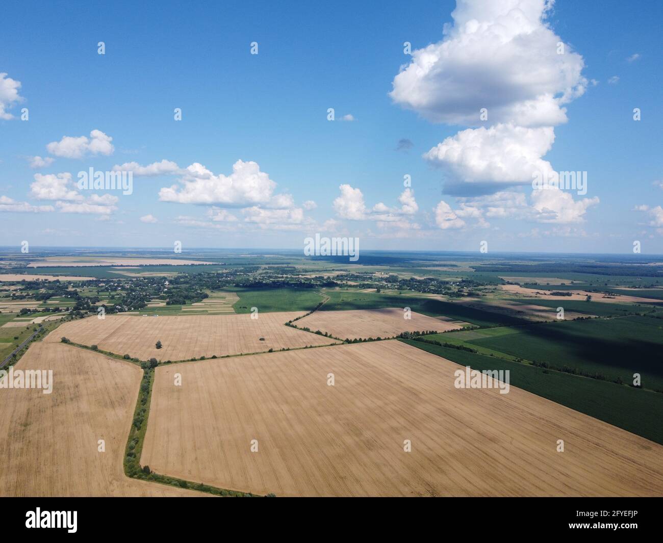 Beautiful agricultural landscape, open field with blue sky and white ...