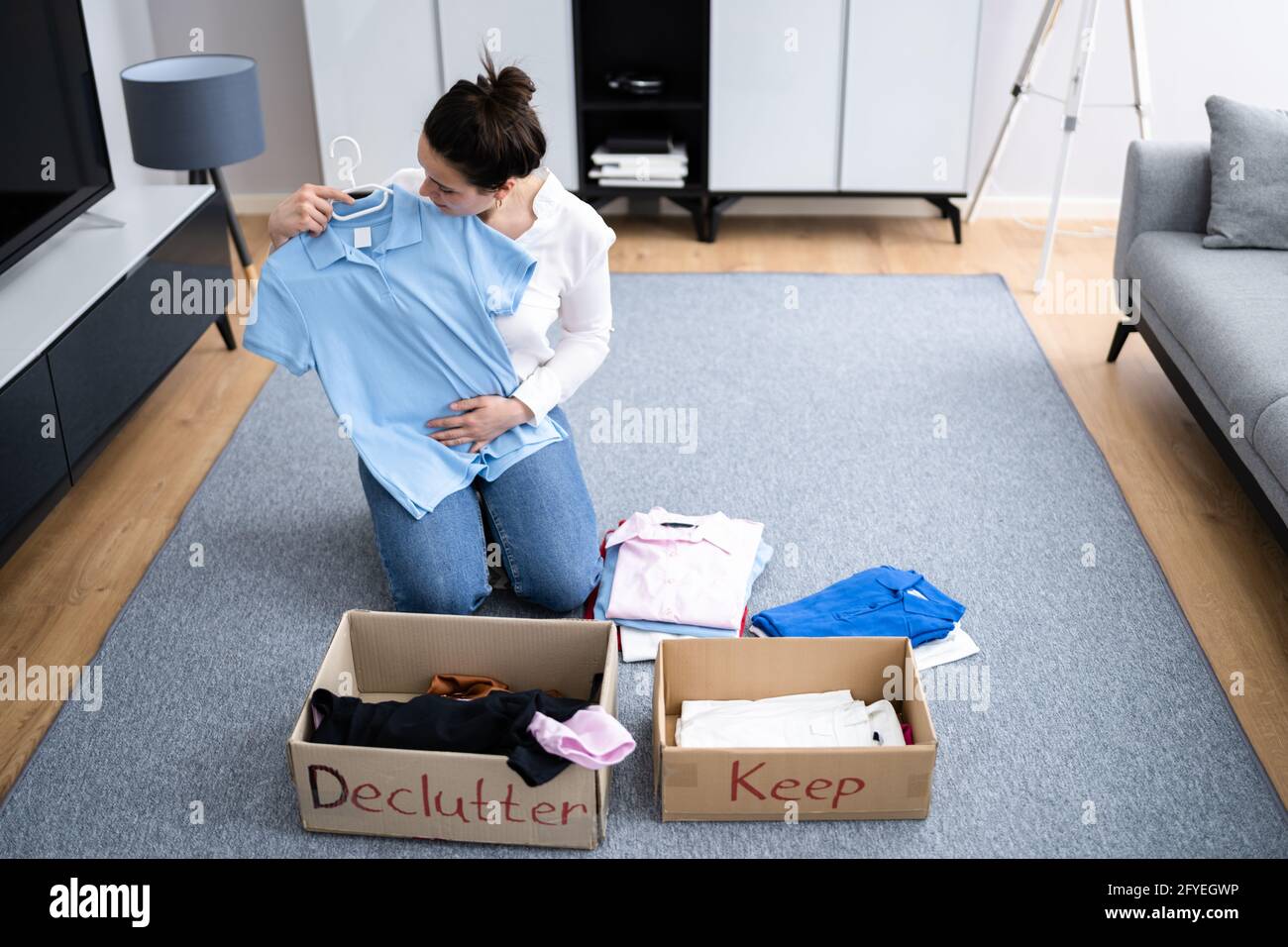 Woman sorting her clothes hi-res stock photography and images - Alamy
