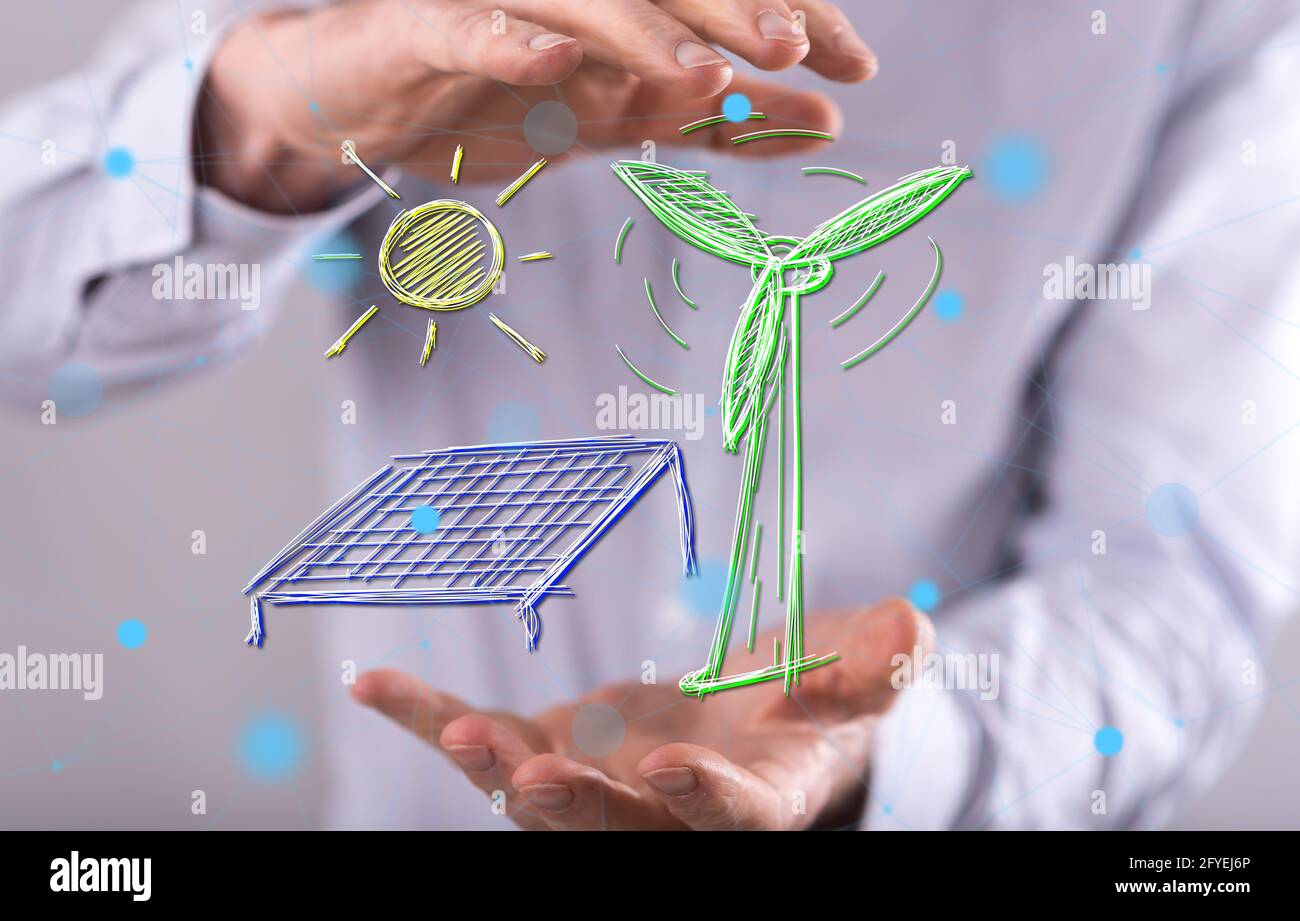 Green energy concept between hands of a man in background Stock Photo ...