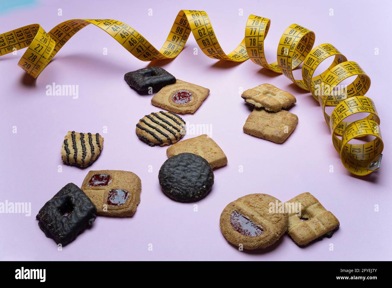 a tape measure between some cookies on a colored surface Stock Photo ...