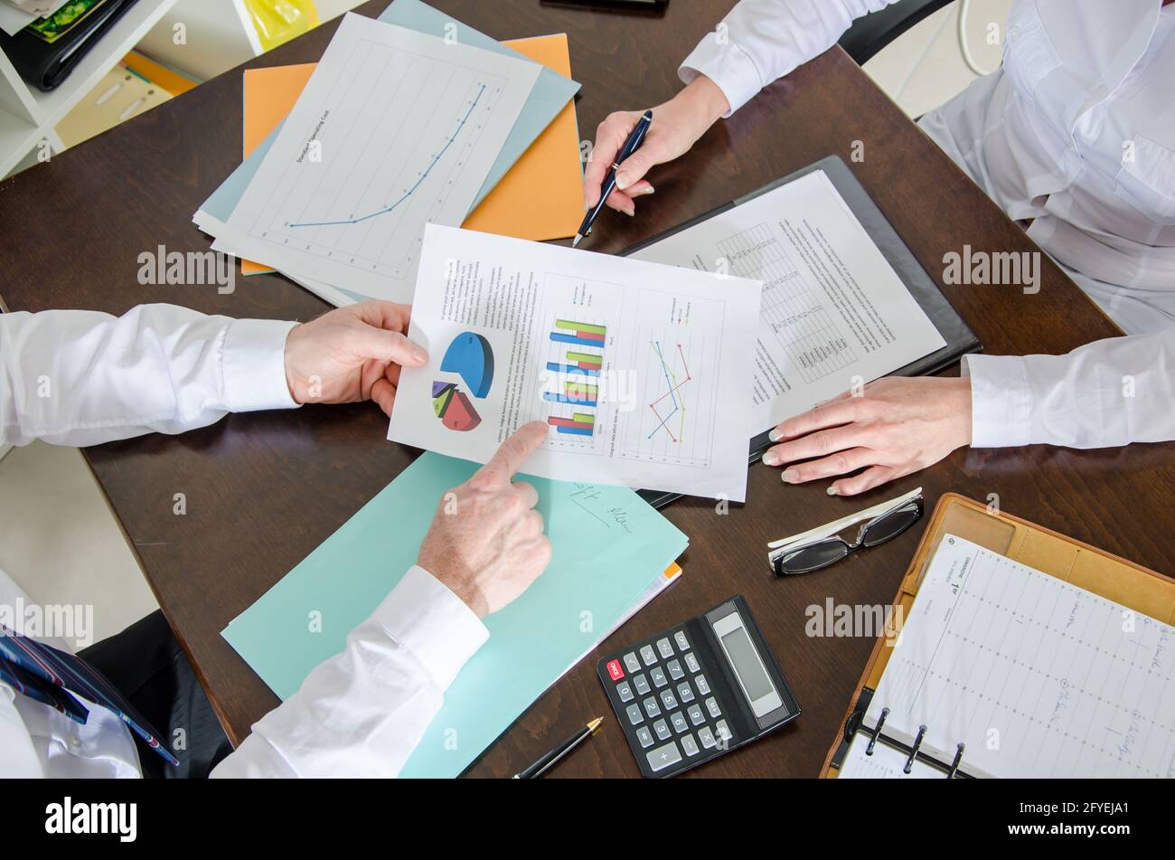 Two business people analyzing charts Stock Photo - Alamy