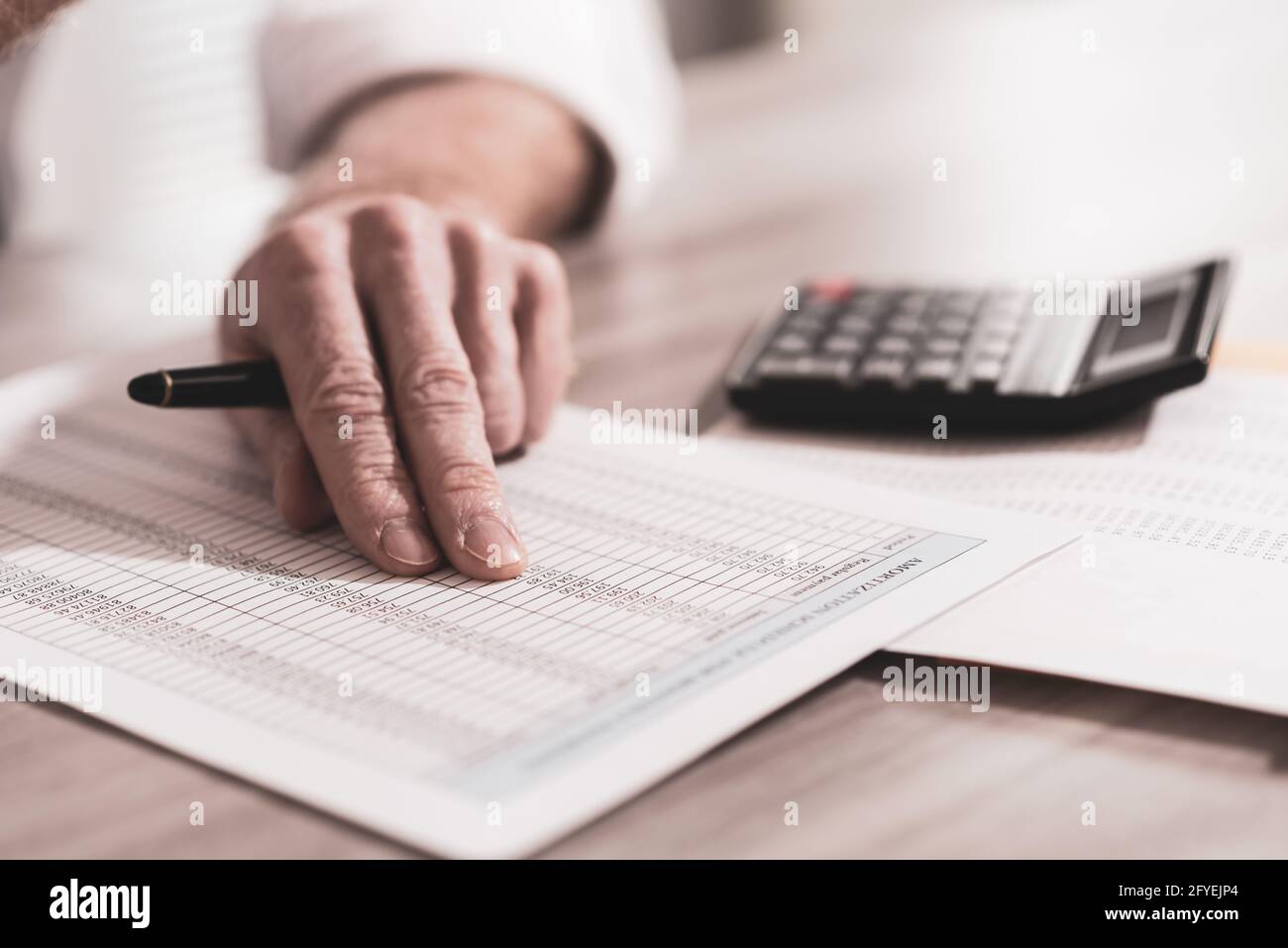 Hand of accountant checking financial document Stock Photo - Alamy