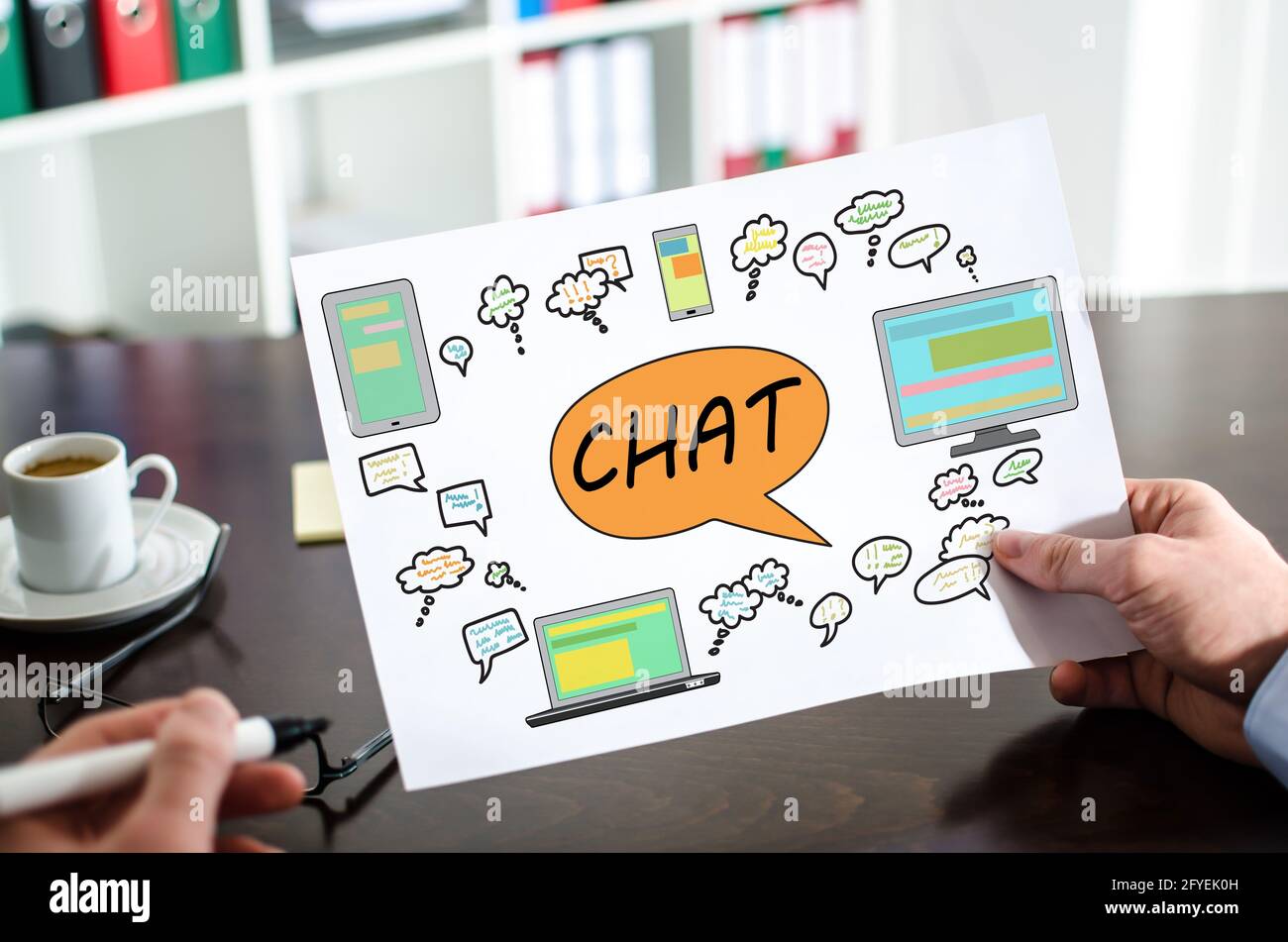 Hand holding a paper showing chat concept Stock Photo - Alamy