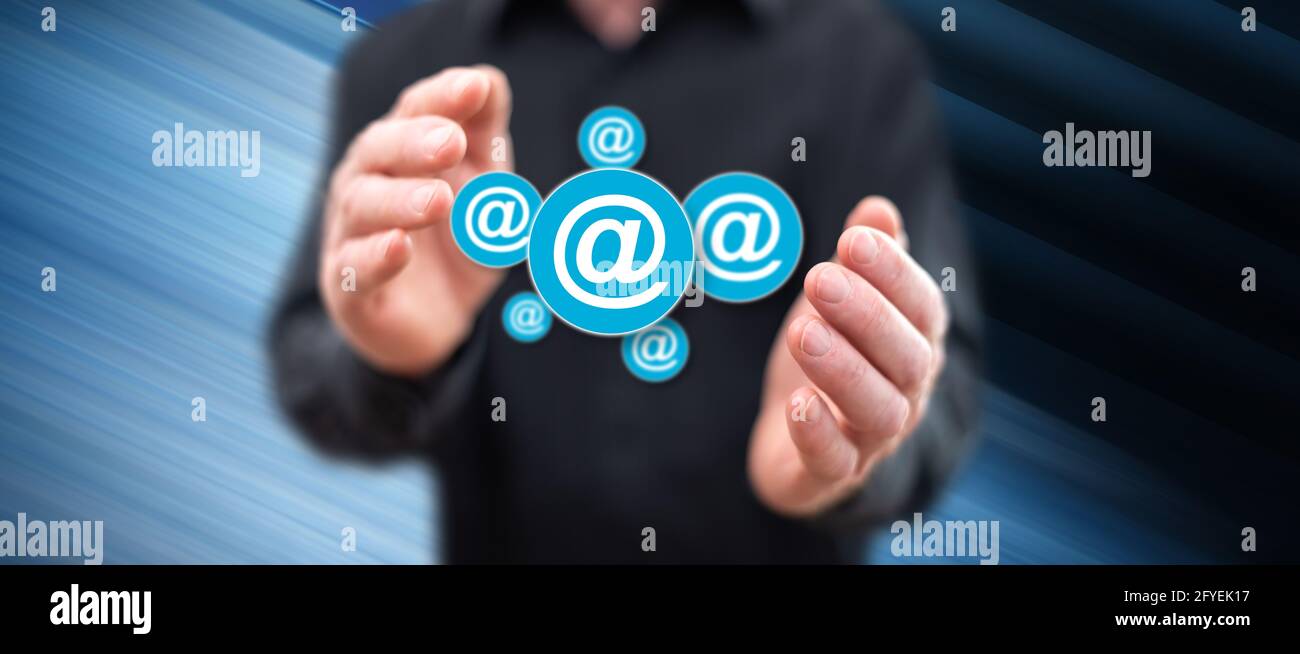Email concept between hands of a man in background Stock Photo - Alamy