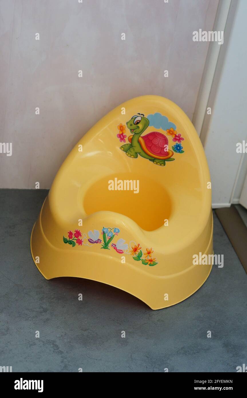 POZNAN, POLAND - Jul 10, 2015: Yellow plastic baby potty with cartoon ...