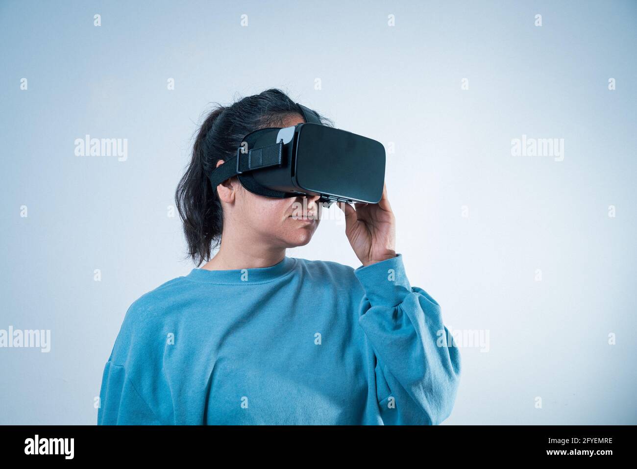 young woman working with vr headset device, moving virtual object with ...