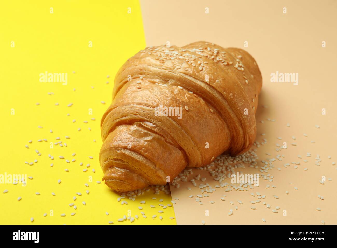 Croissant and sesame on two tone background, close up Stock Photo - Alamy