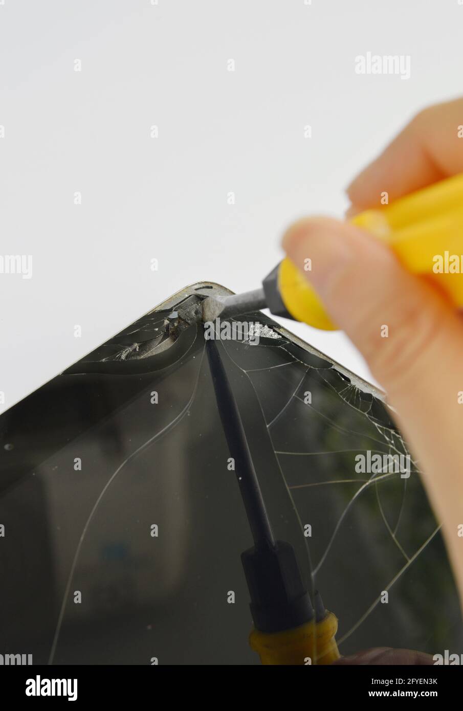 Hand holding screwdriver, breaking a tablet's touchscreen Stock Photo ...