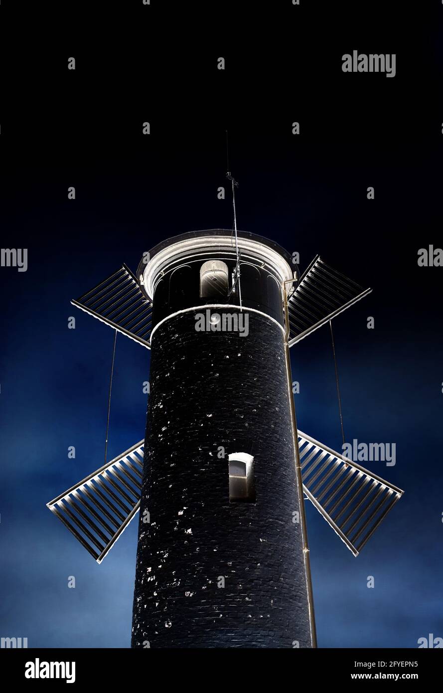 Silhouette of a windmill against the dark night sky. Night decor with ...