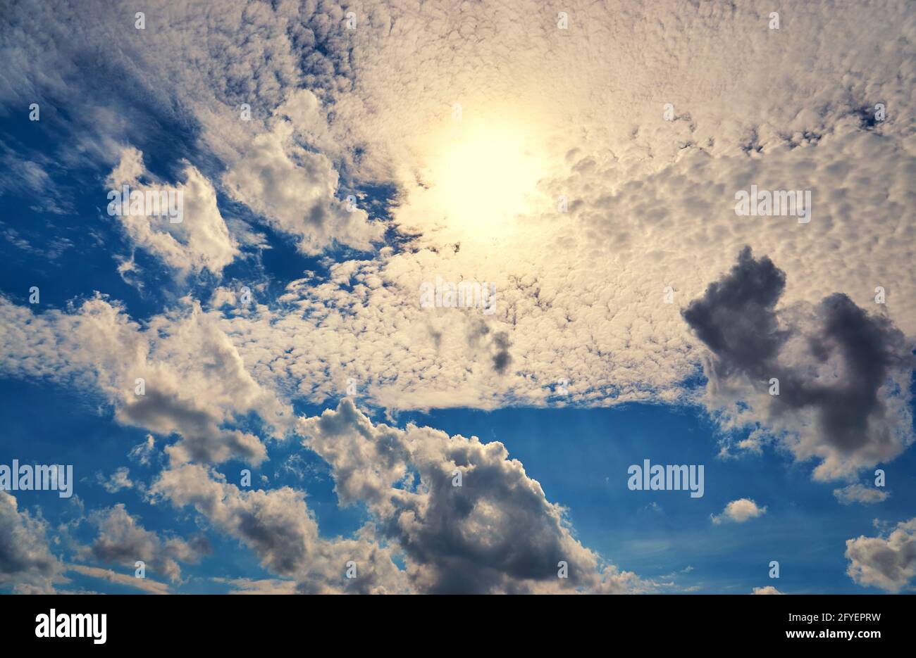 Beautiful blue sky with sun rays and clouds. Sun rays in the background ...