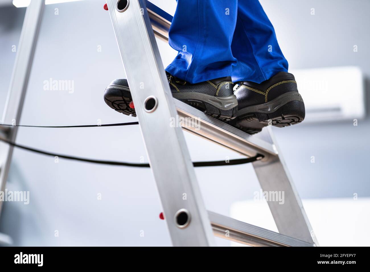 Man In Shoes Climbing Step Ladder. Safety And Insurance Stock Photo - Alamy