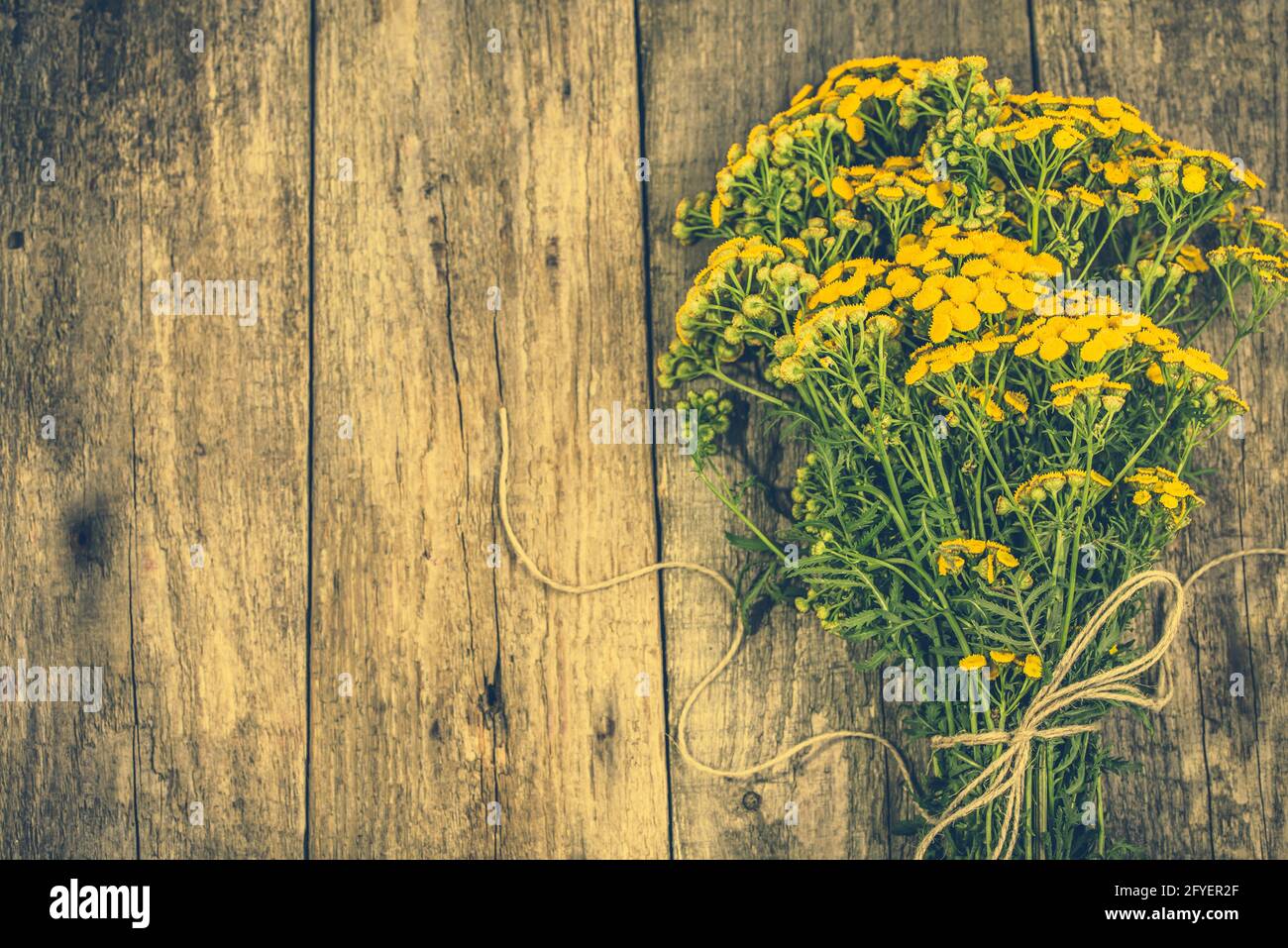 Yellow flowers from summer meadow, rustic bouquet located on wooden ...