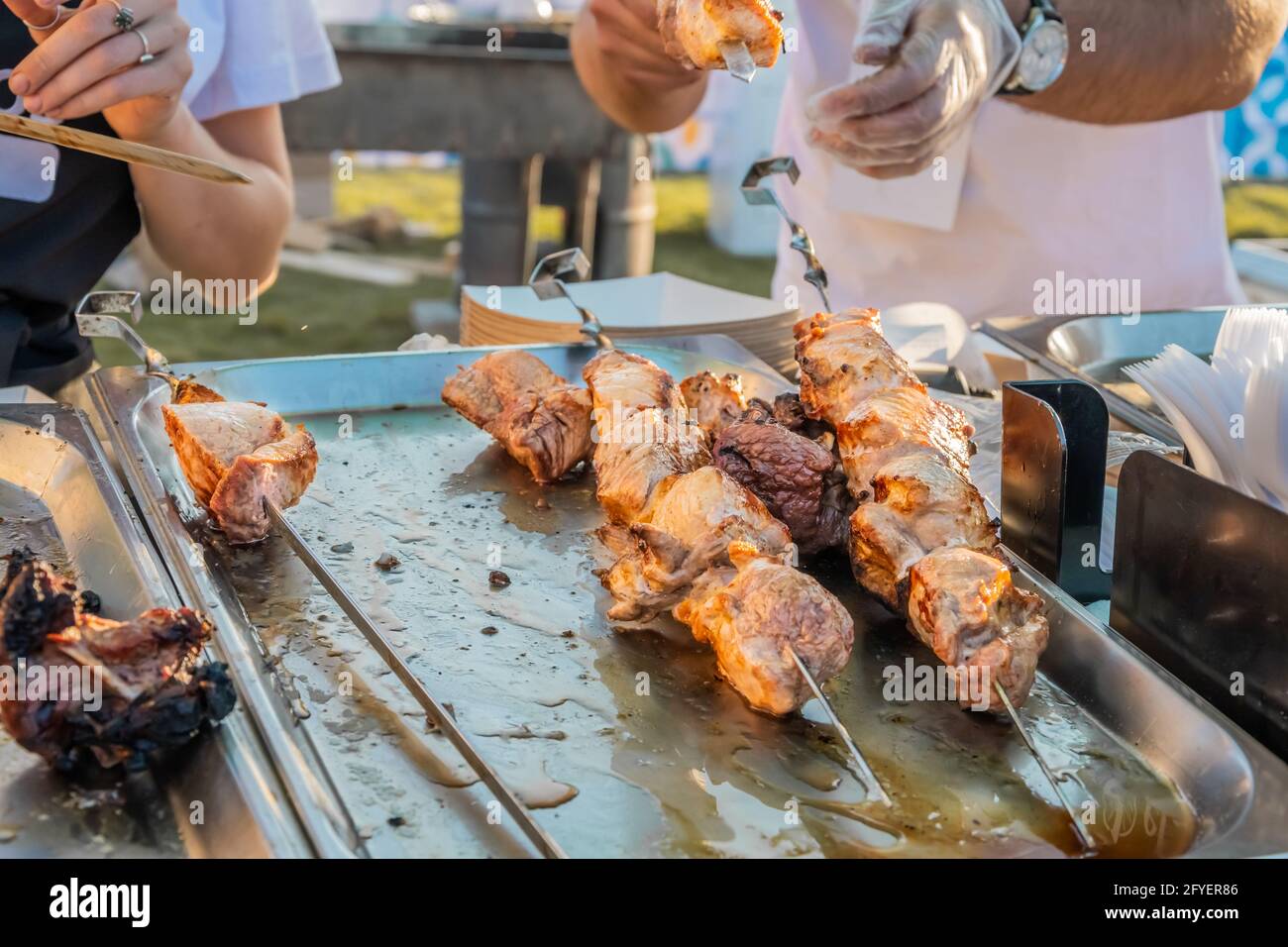 Fried shish kebab on skewers on the counter of a street restaurant ...