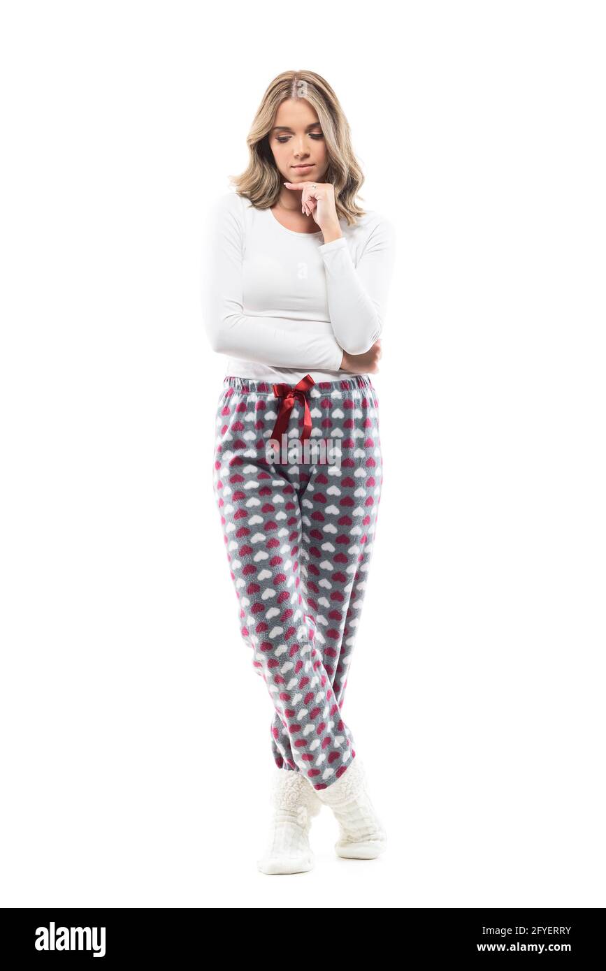 Thoughtful Young Pretty Woman In Pajamas Contemplating Looking Down With Finger On Chin Full