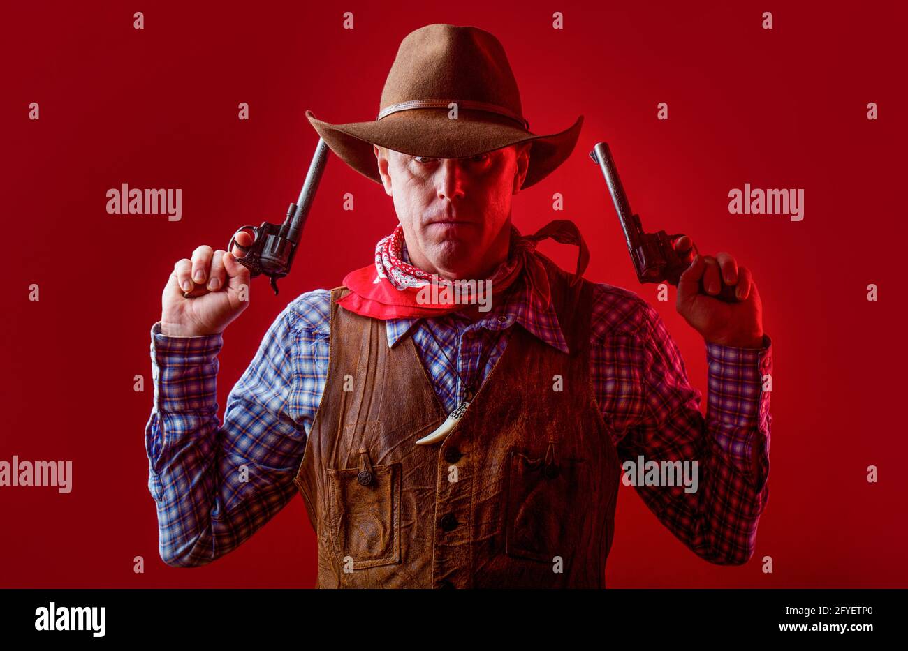 Man wearing cowboy hat, gun. Portrait of a cowboy. West, guns. Portrait ...
