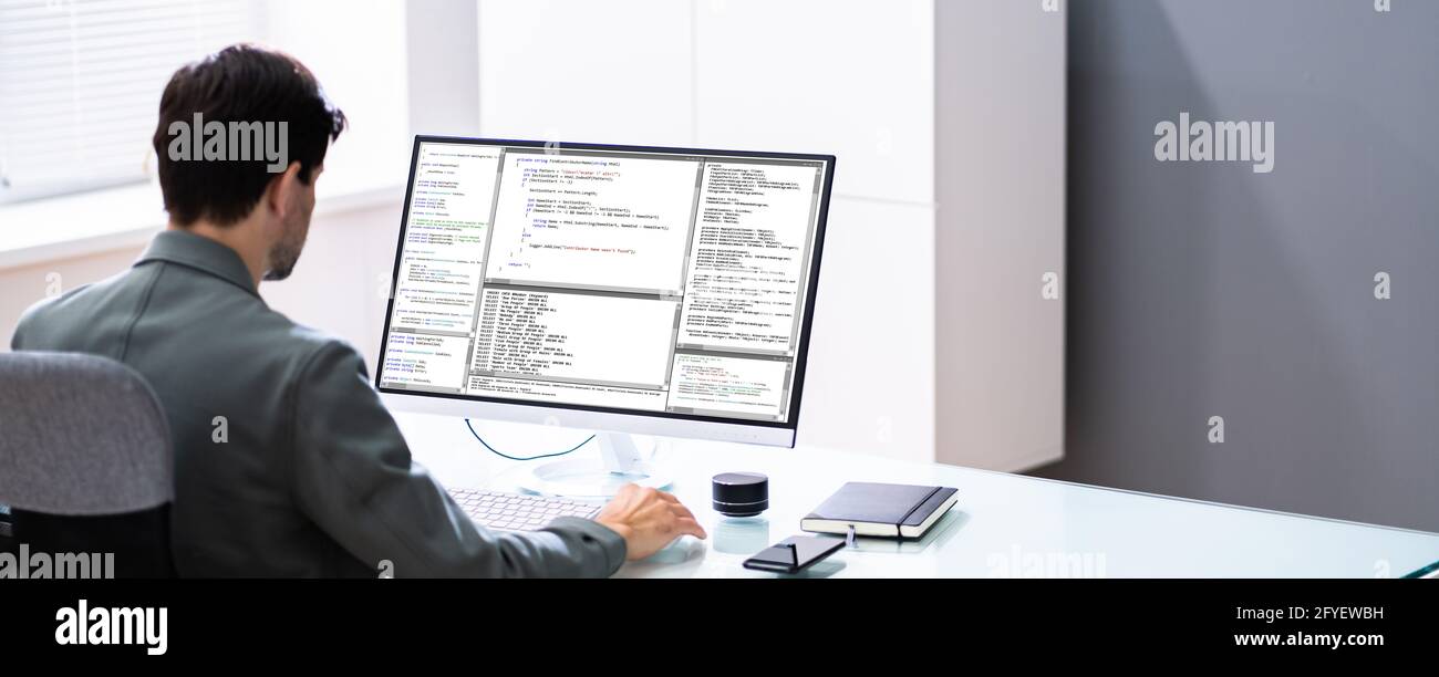 Programmer Or Coder At Office Desk Using Laptop Stock Photo - Alamy