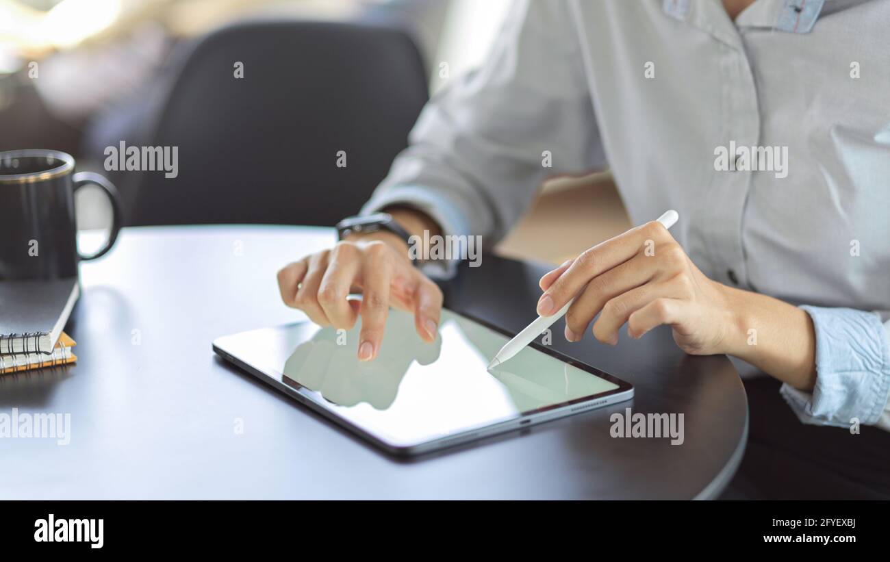 Close up view of young female using mock up blank screen digital tablet ...