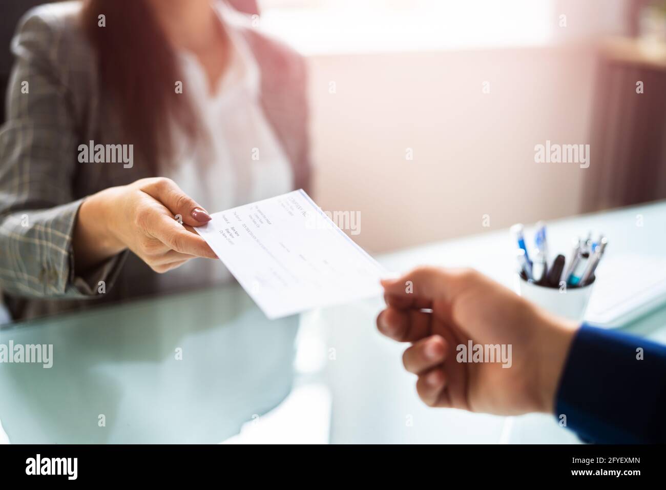 Woman Giving Cheque. Hand Holding Insurance Check Stock Photo - Alamy